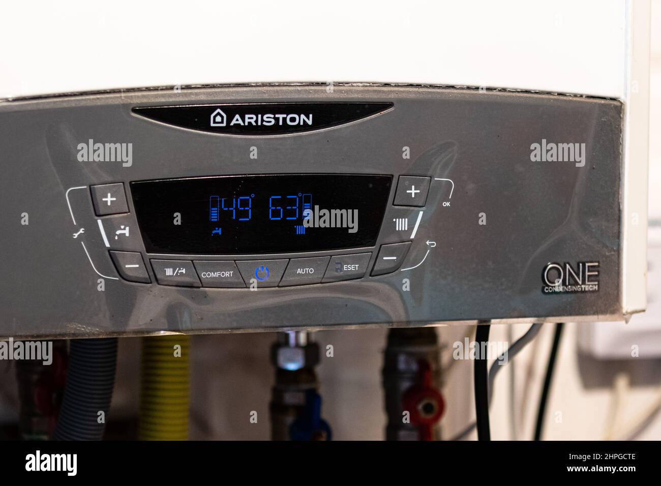 Girl hand setting temperature to heating system. Central heating ...