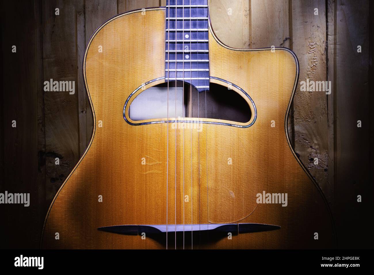 Beautifully gipsy jazz acoustic guitar details, hanged on wooden wall ...
