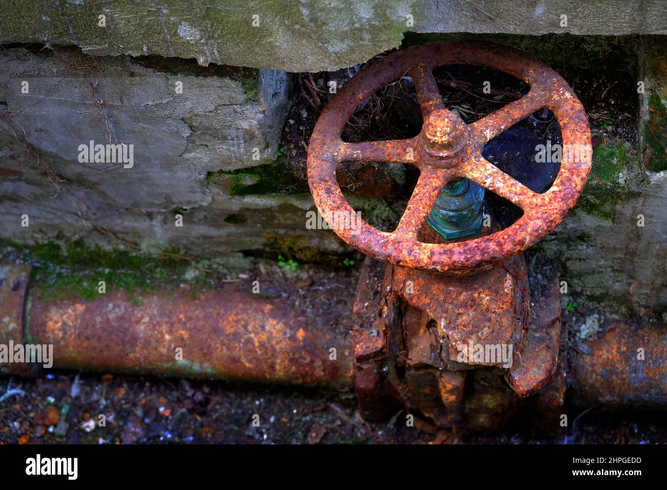 Old rusted and broken iron water pipe with valve turn wheel rust Stock ...