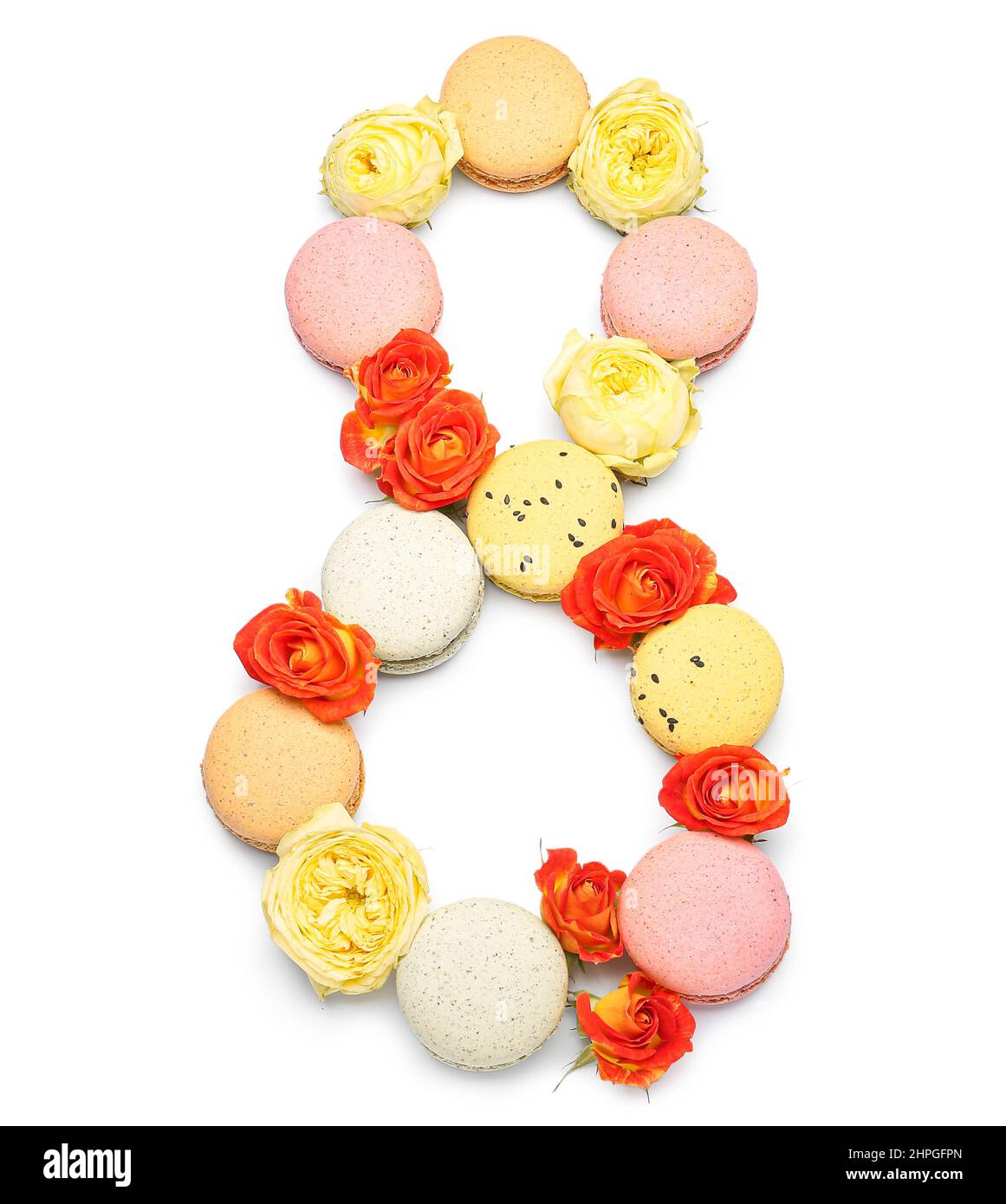 Figure 8 made of tasty macaroons and rose flowers on white background ...