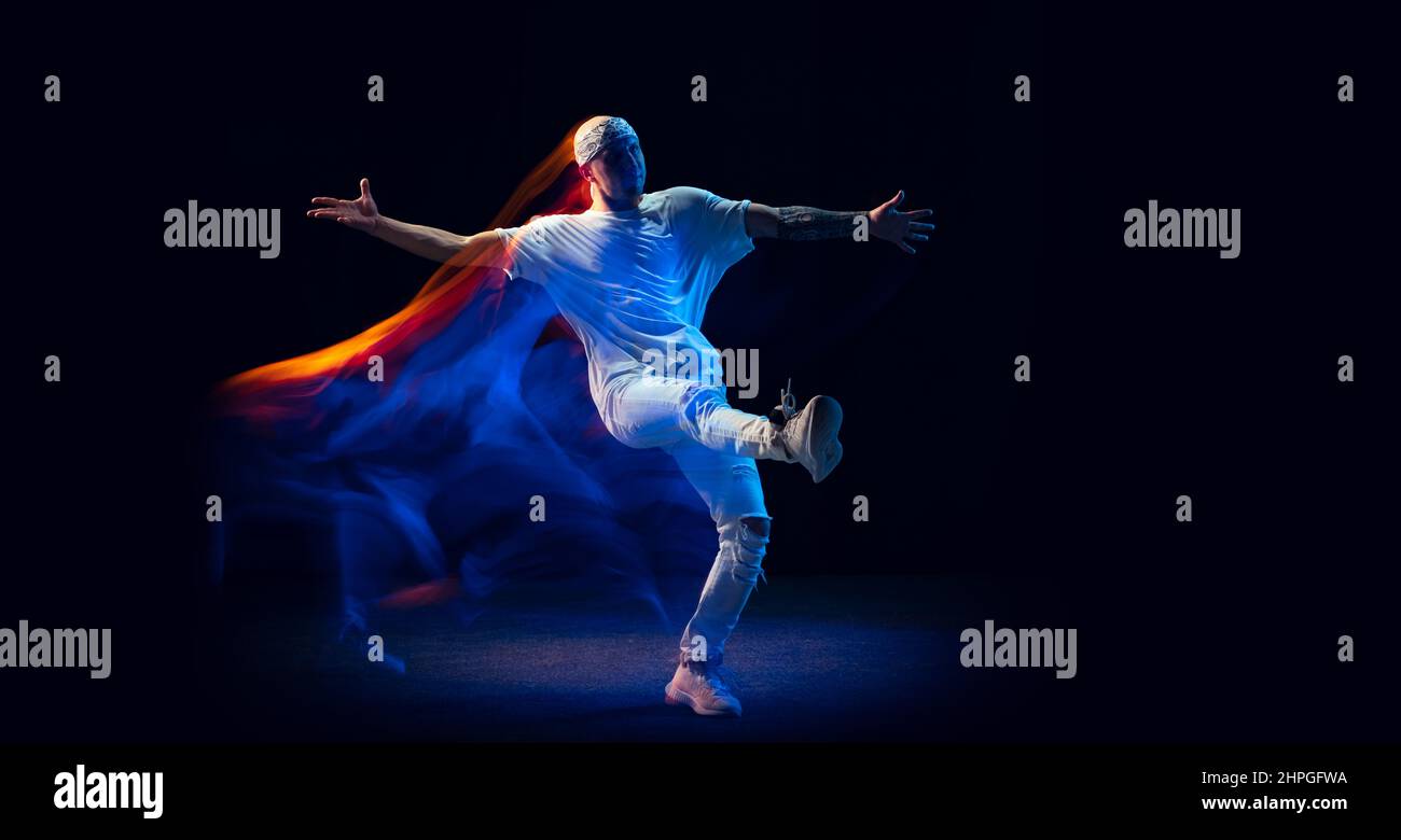 Split personality. Sportive man in sports white uniform and do-rag ...