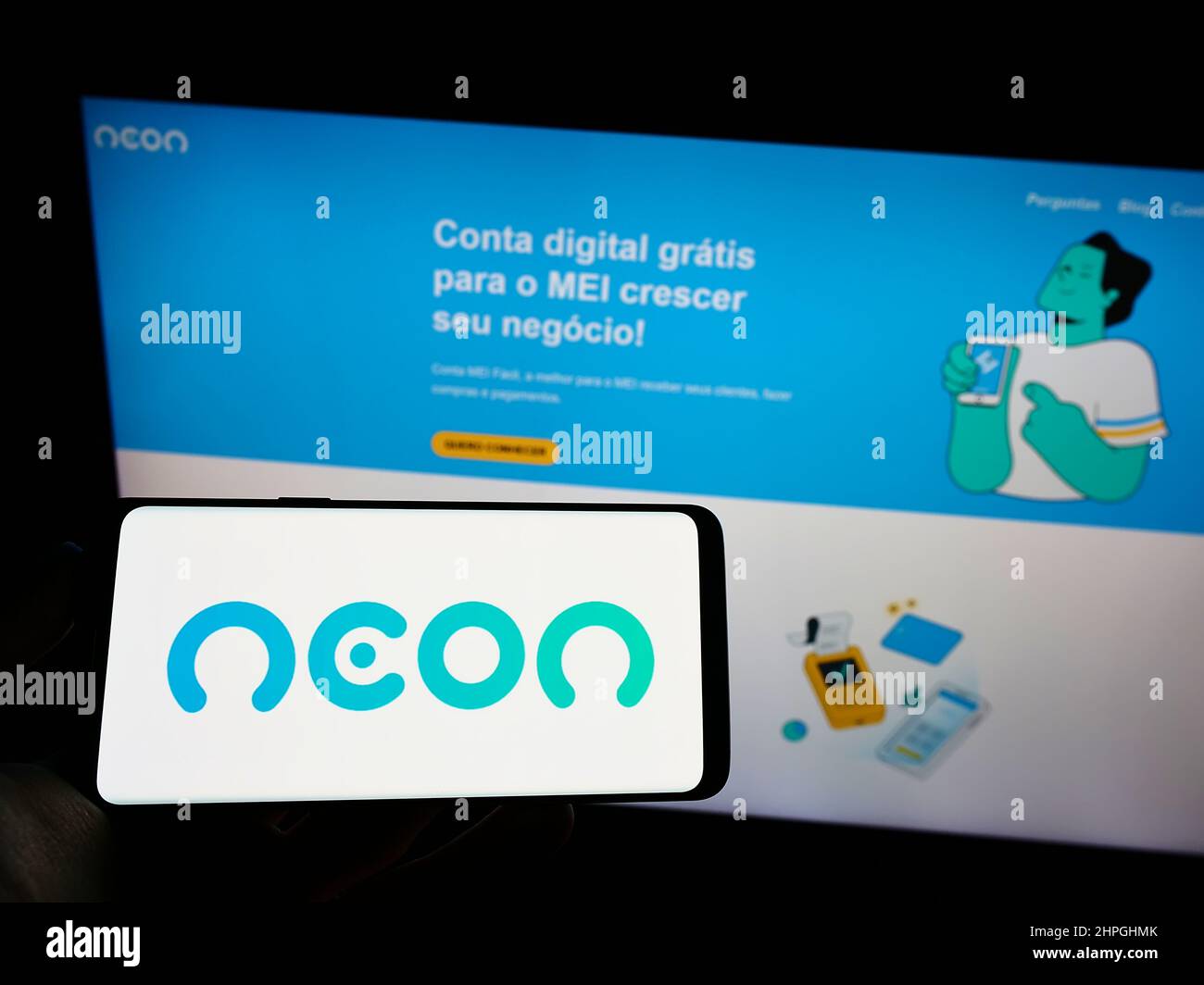 Person holding mobile phone with logo of Brazilian fintech company Neon ...