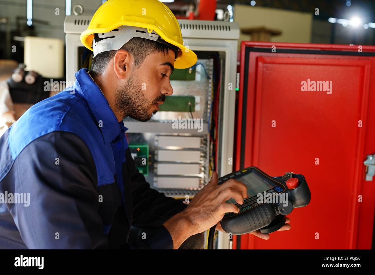 engineer checking control panel and teaching new Automatics robot arm ...