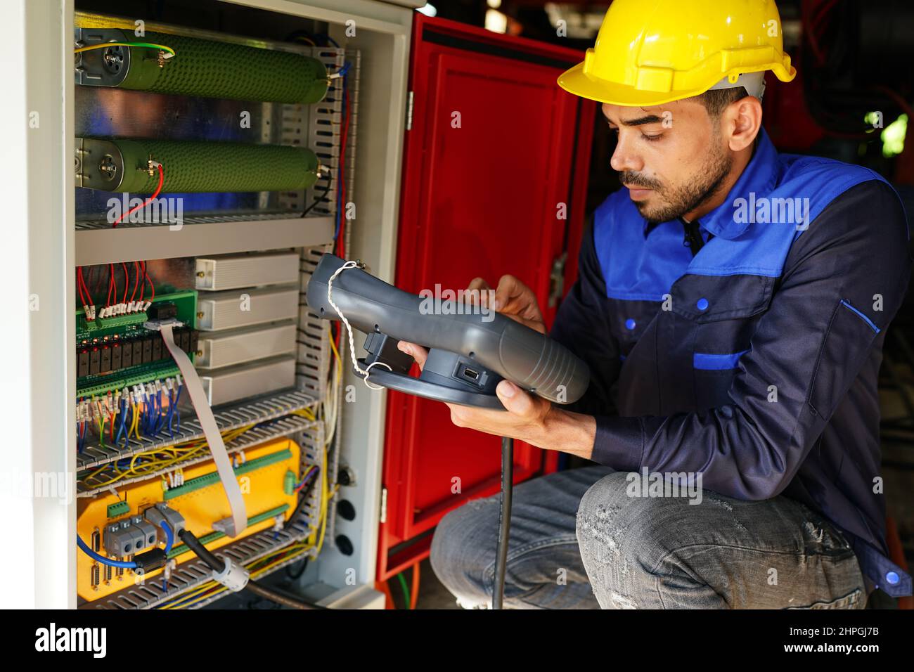 engineer checking control panel and teaching new Automatics robot arm ...