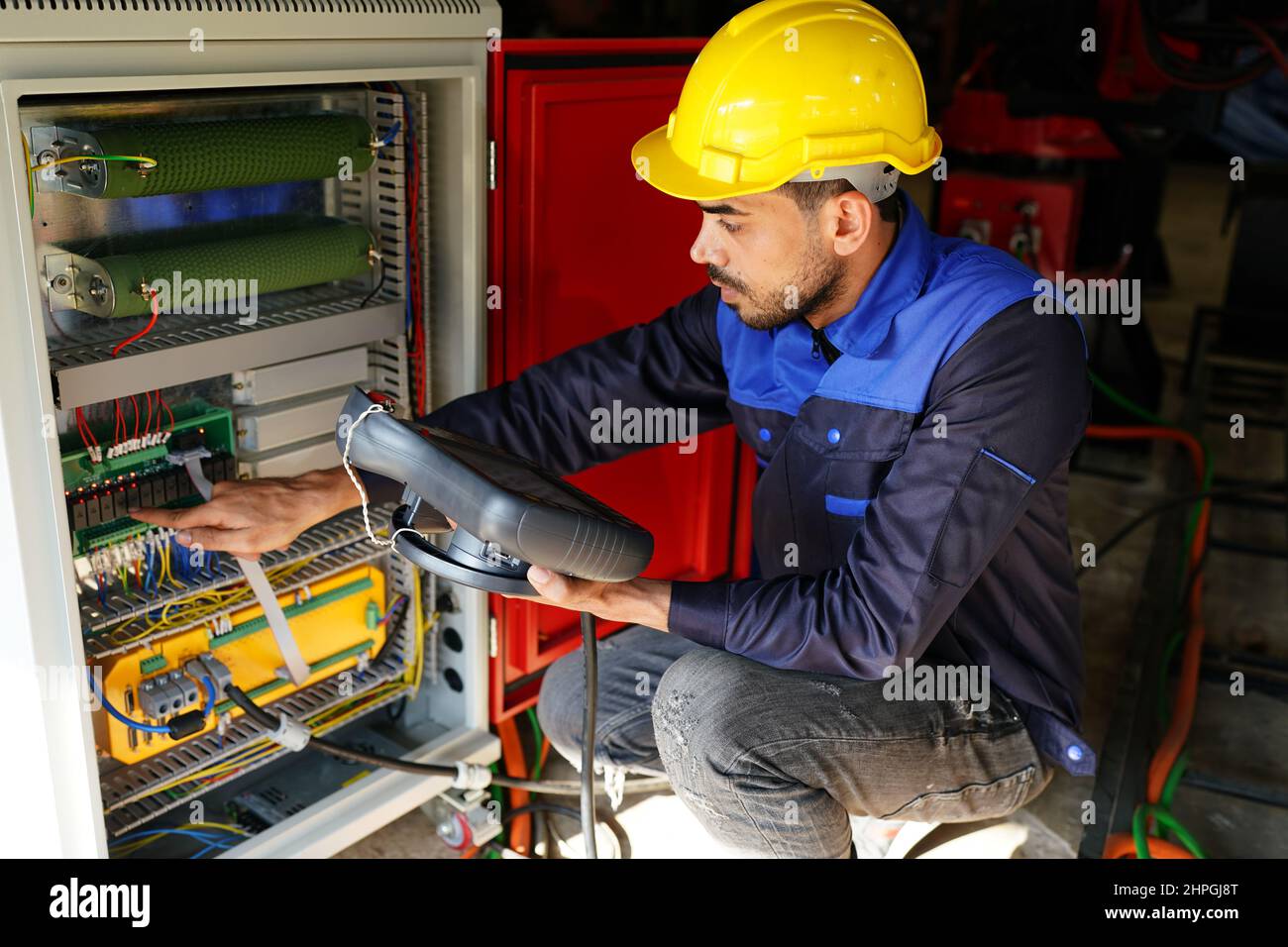 engineer checking control panel and teaching new Automatics robot arm ...