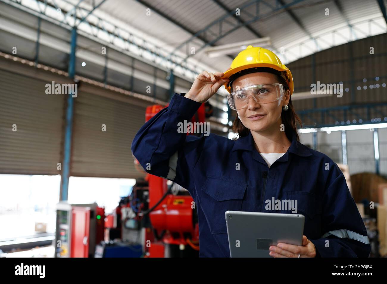 Professional young industrial factory woman employee working with ...