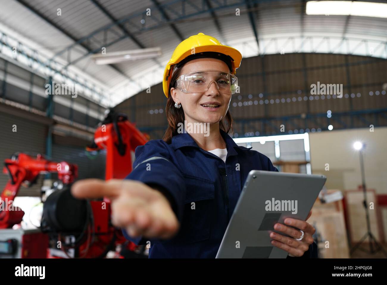 Professional young industrial factory woman employee working with ...
