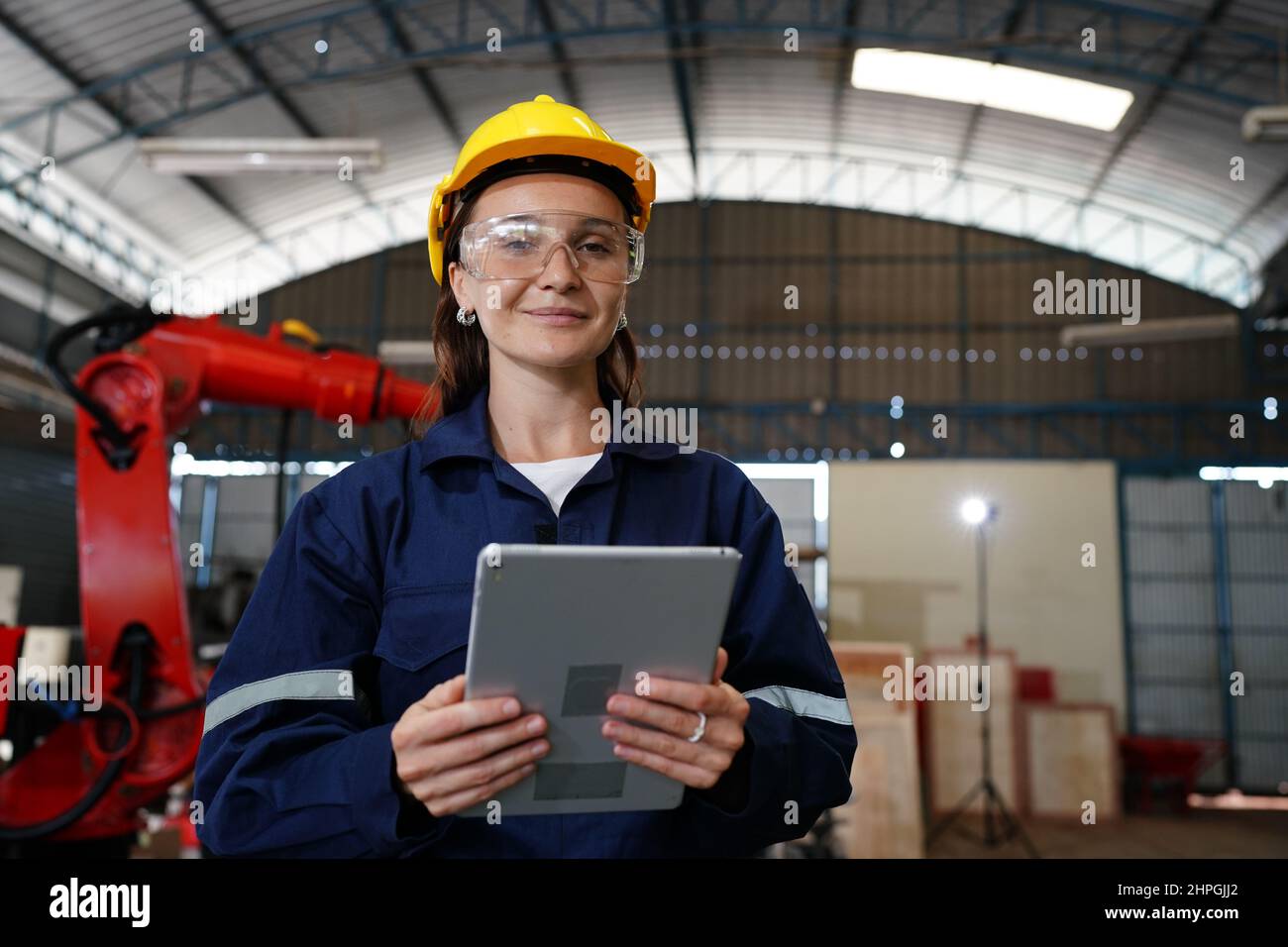 Professional young industrial factory woman employee working with ...