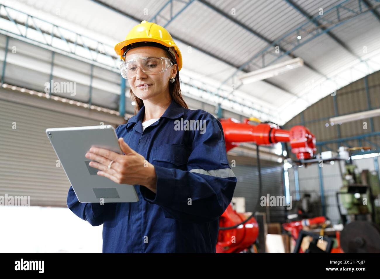 Professional young industrial factory woman employee working with ...
