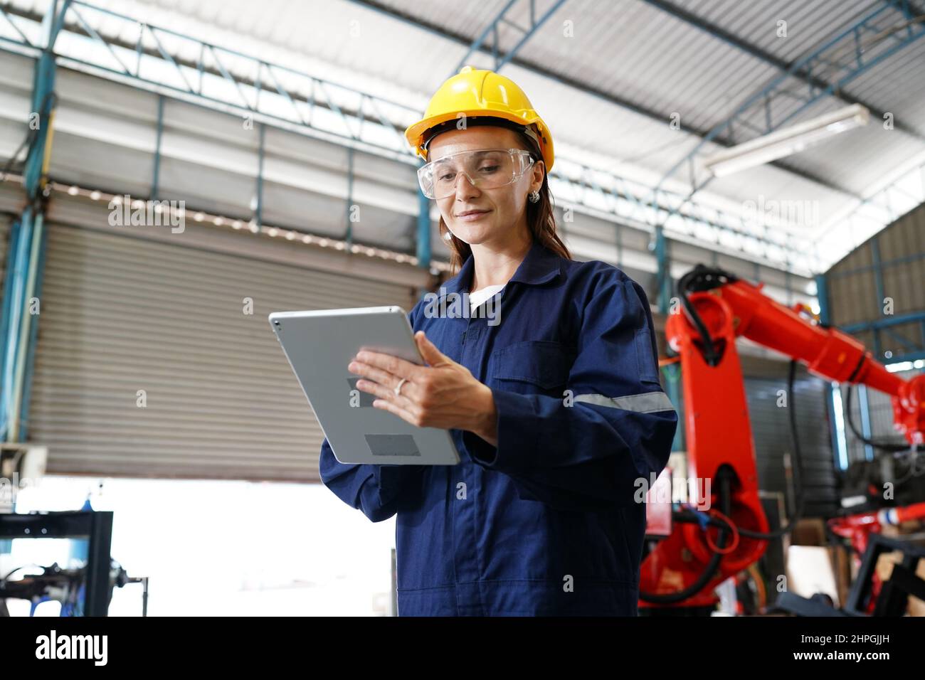 Professional young industrial factory woman employee working with ...