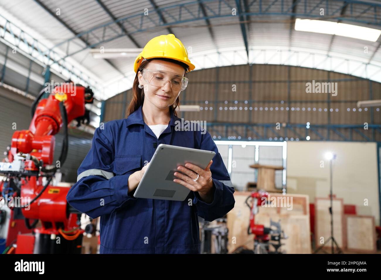 Professional young industrial factory woman employee working with ...