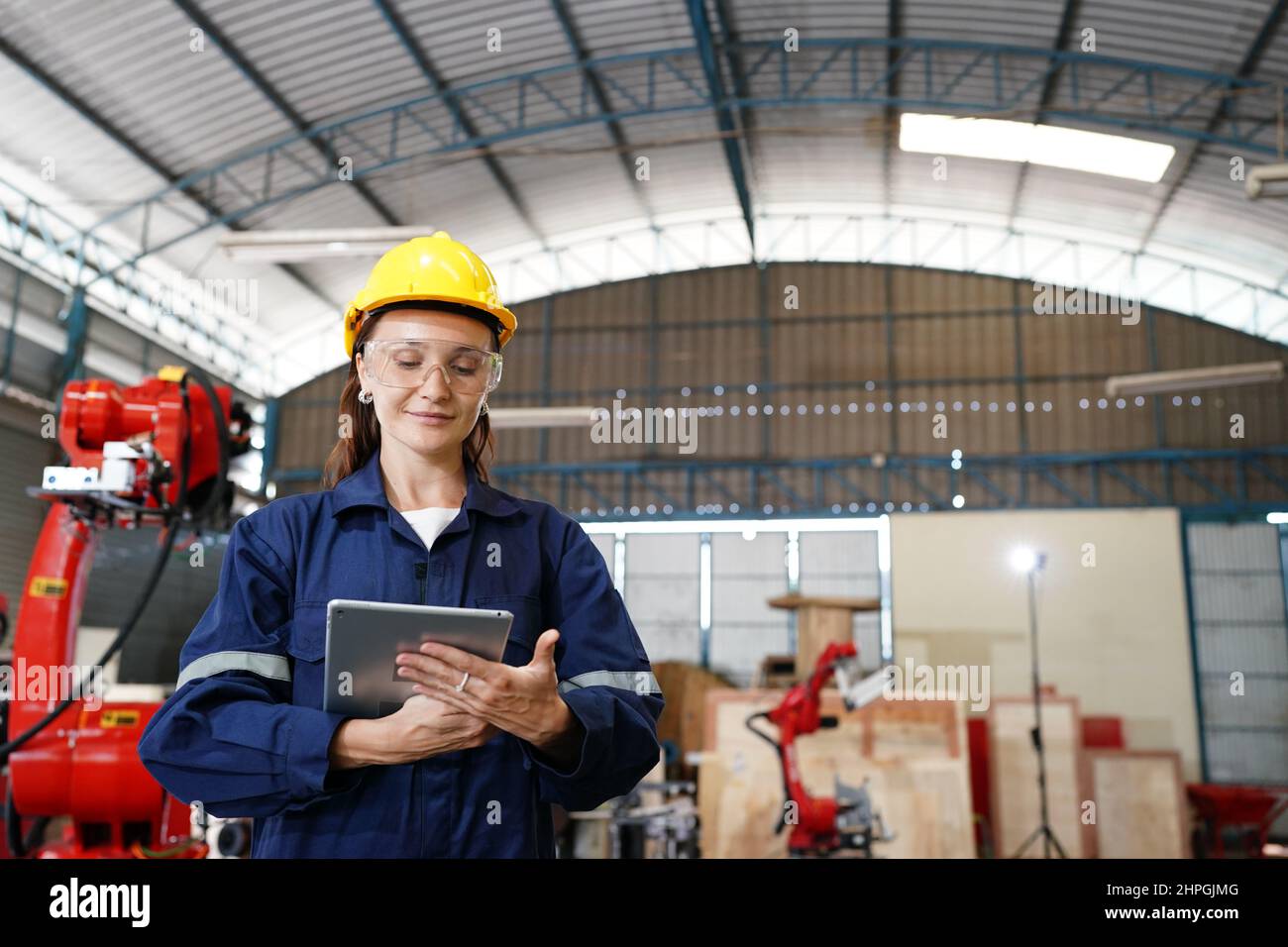 Professional young industrial factory woman employee working with ...