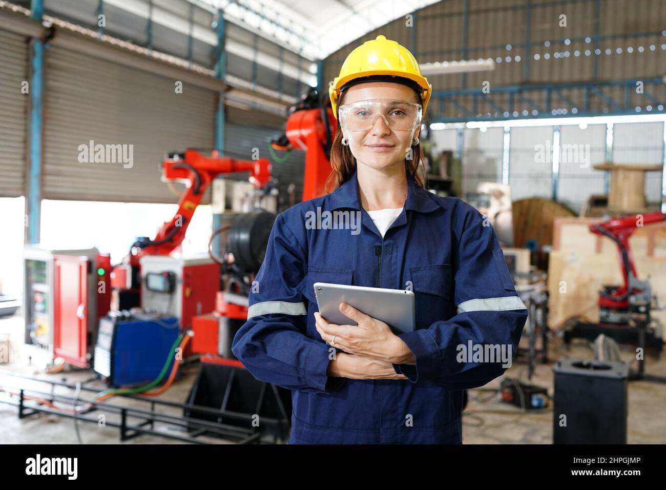 Professional young industrial factory woman employee working with ...