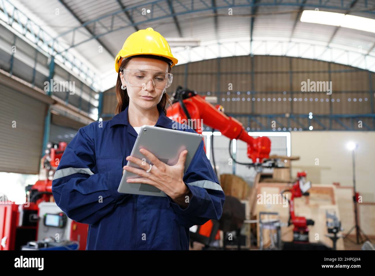 Professional young industrial factory woman employee working with ...