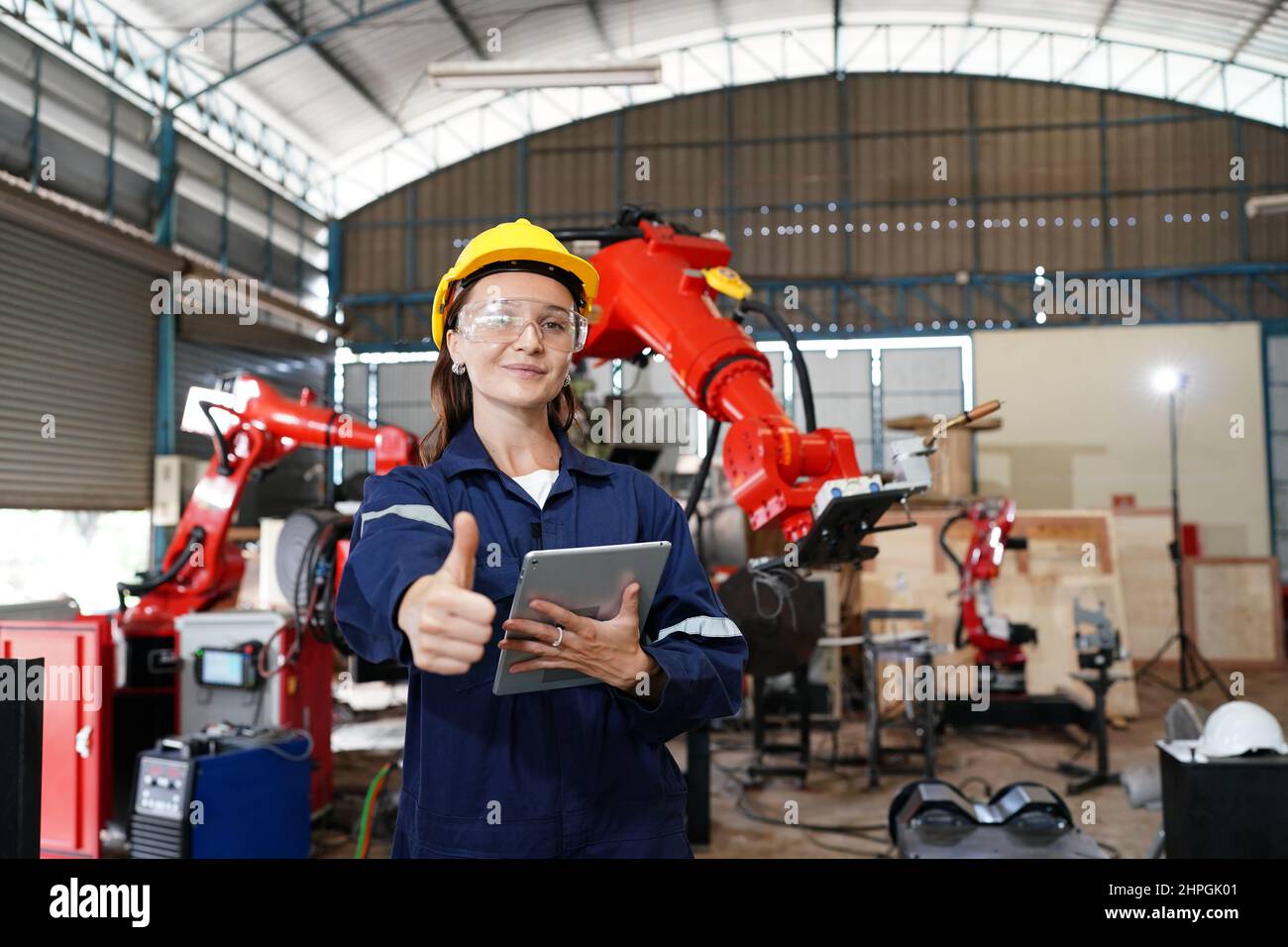 Professional young industrial factory woman employee working with ...
