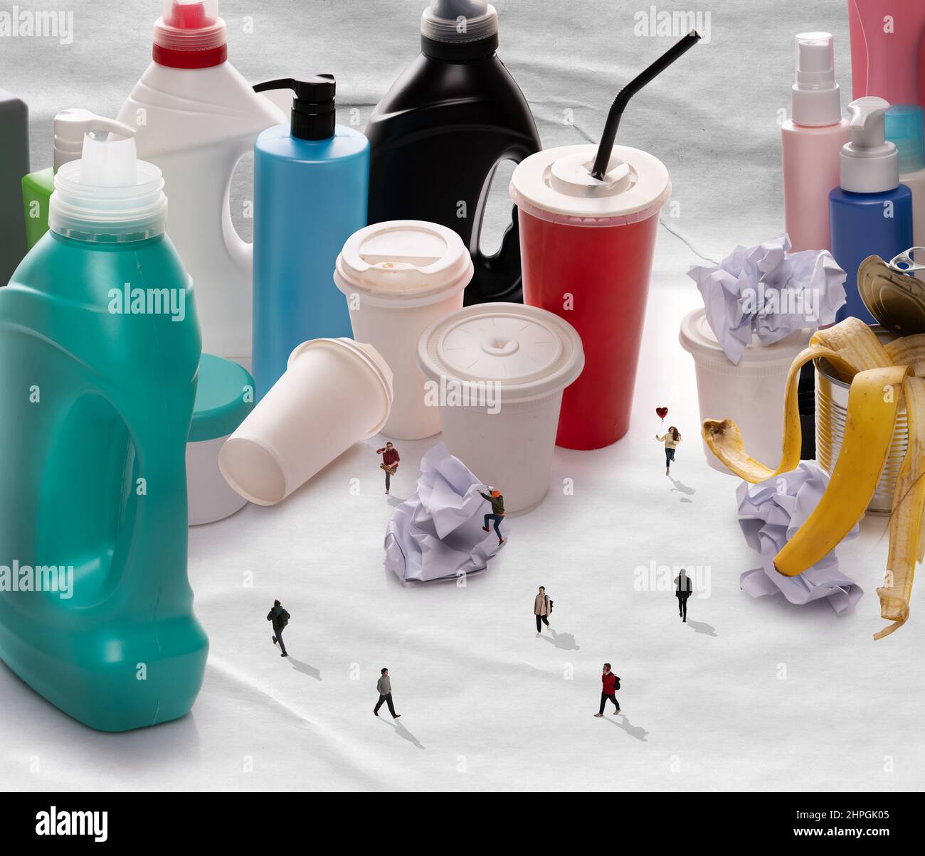 Garbage-monster. Tiny men and women in city made of rubbish, plastic ...