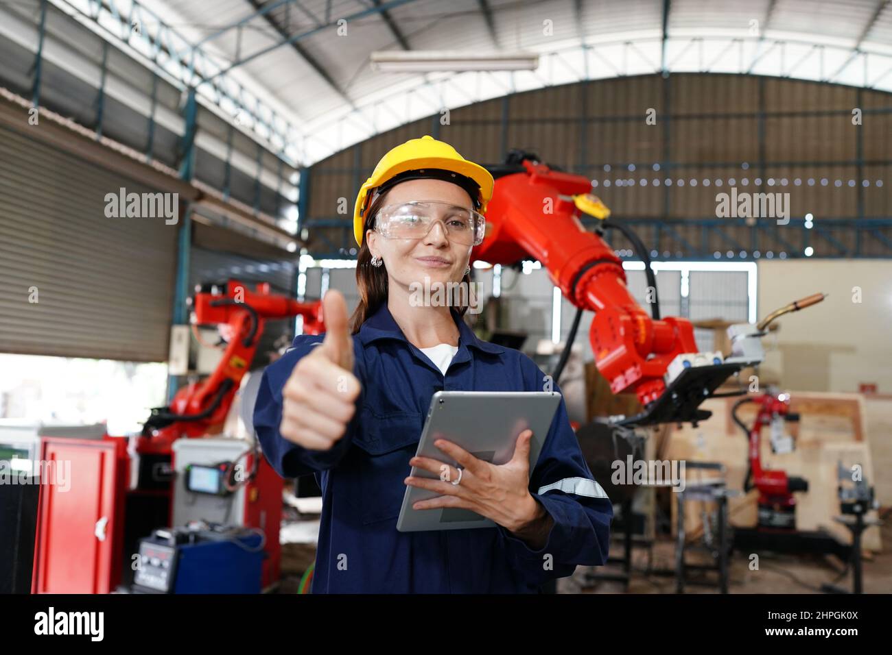 Professional young industrial factory woman employee working with ...
