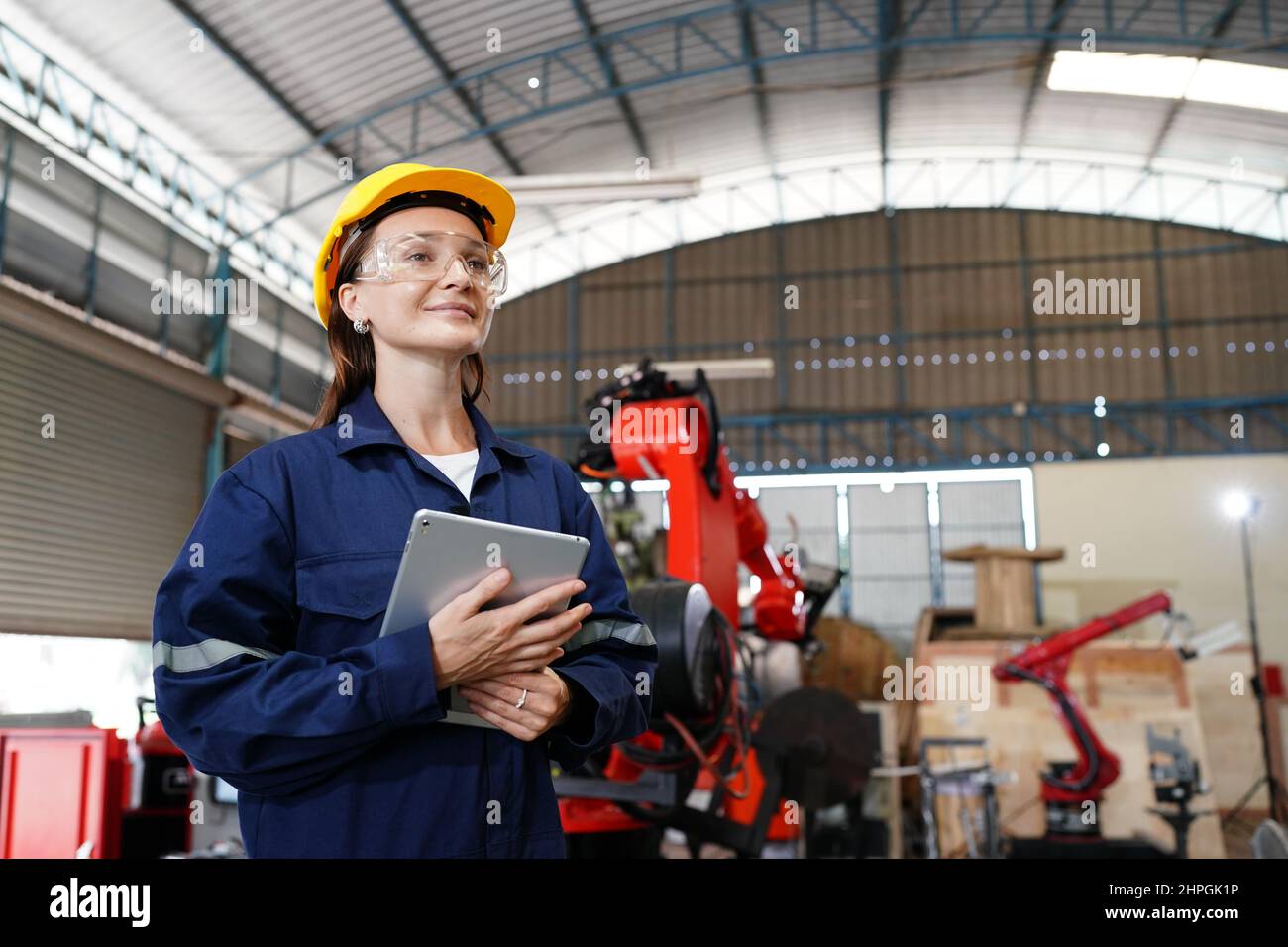 Professional young industrial factory woman employee working with ...