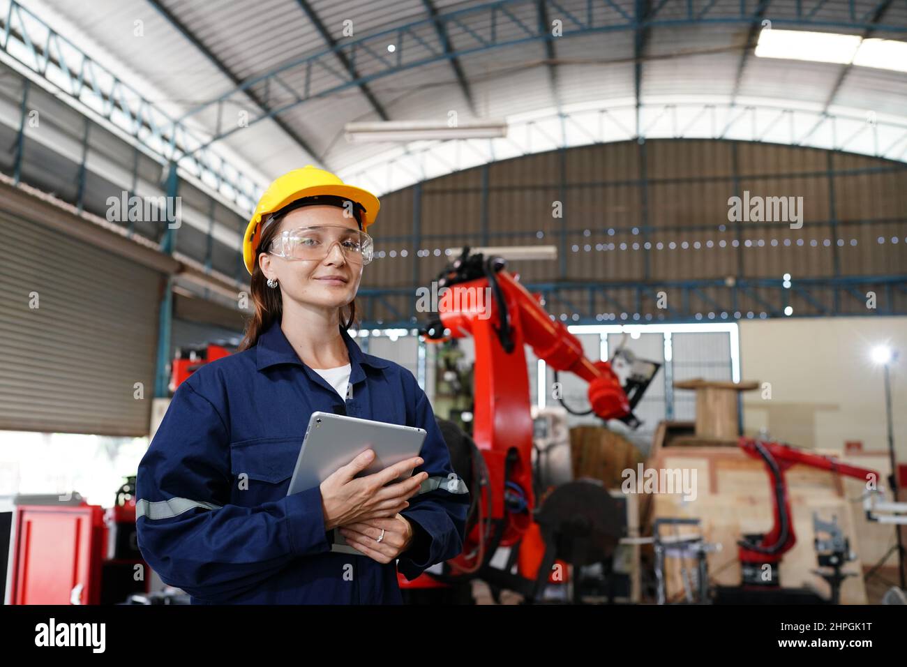 Professional young industrial factory woman employee working with ...