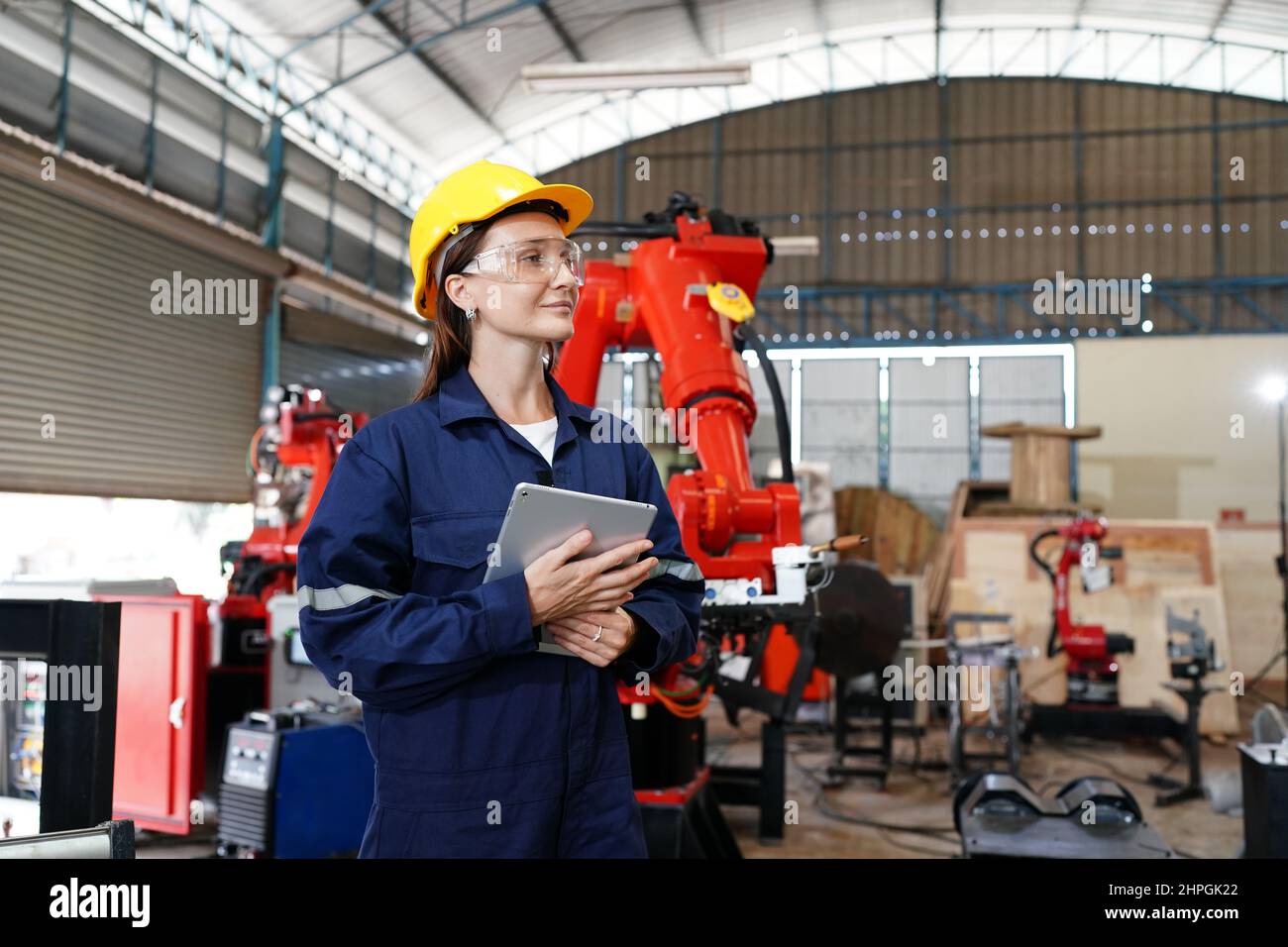 Professional young industrial factory woman employee working with ...