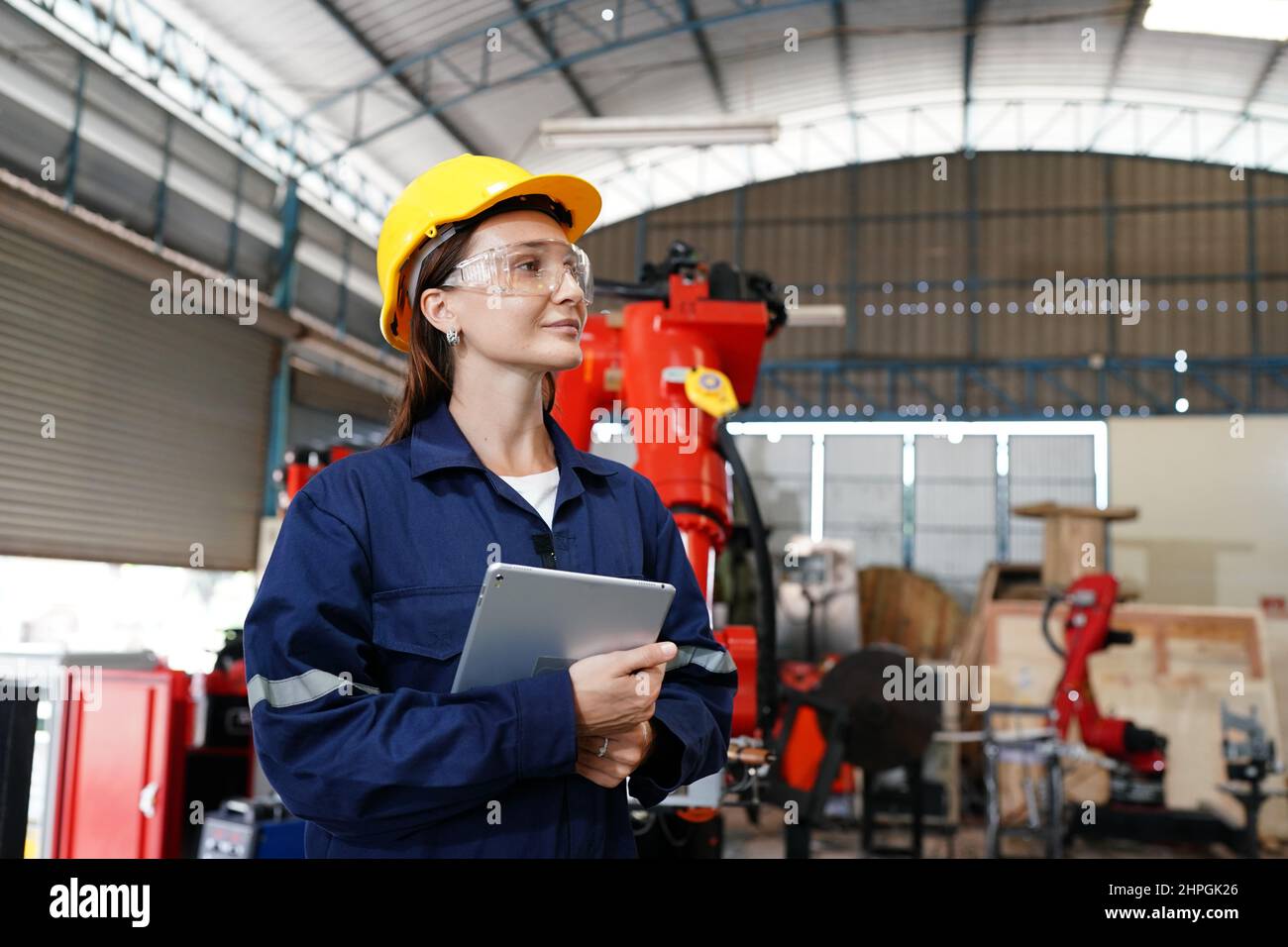Professional young industrial factory woman employee working with ...