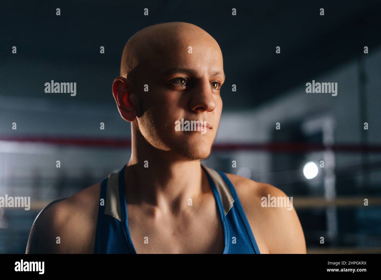 Close-up face of professional bald brutal boxer wearing sportswear ...