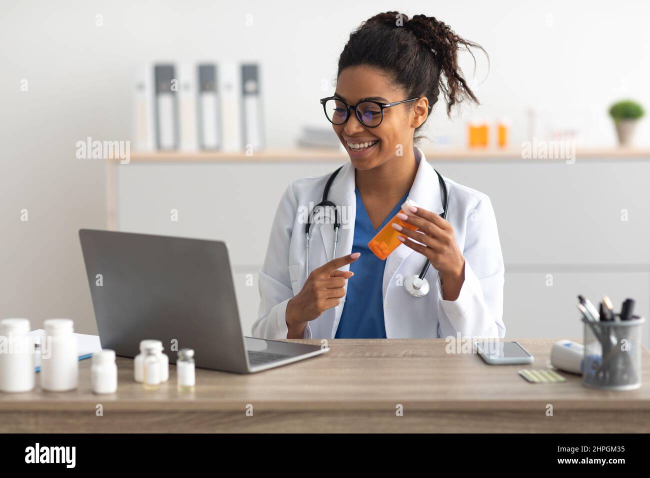Portrait of black female medical practitioner using laptop Stock Photo ...