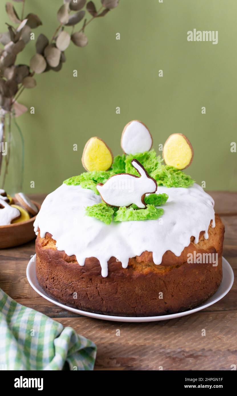 Easter cake with raisins decorated with white icing and gingerbread in ...