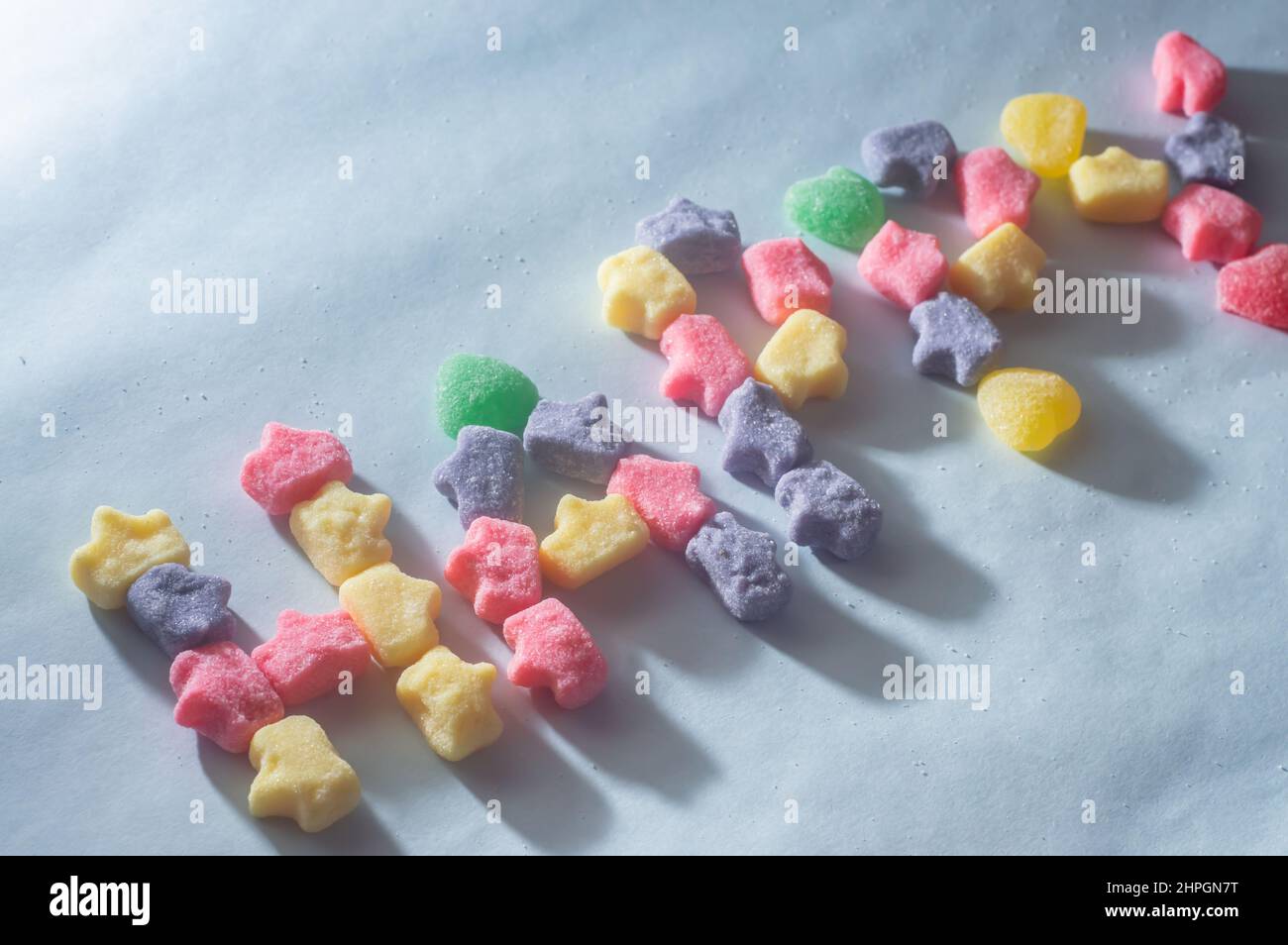 Colorful sweets varied with the word "Happy" written,light blue ...