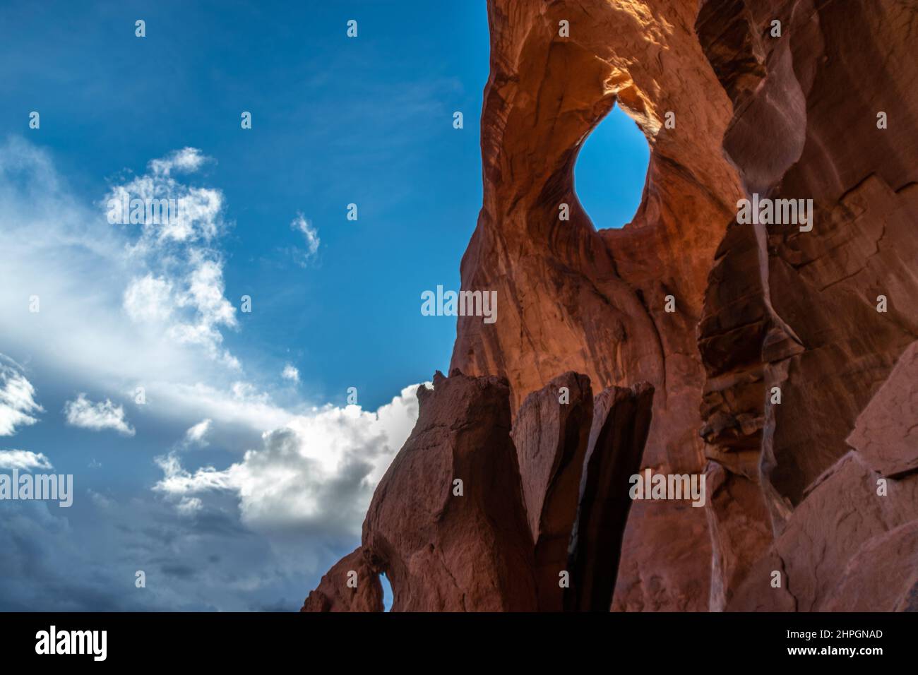 Naturally occurring Arch with a blue sky in Monument Valley Stock Photo ...