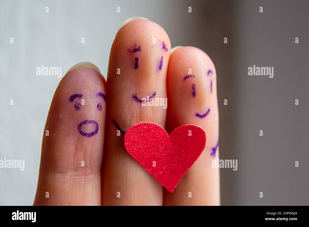 Smiley faces drawn on fingers. Mother, father and child happy family ...