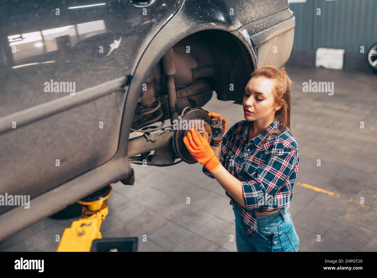 Female auto mechanic. beautiful young red-headed girl in working ...