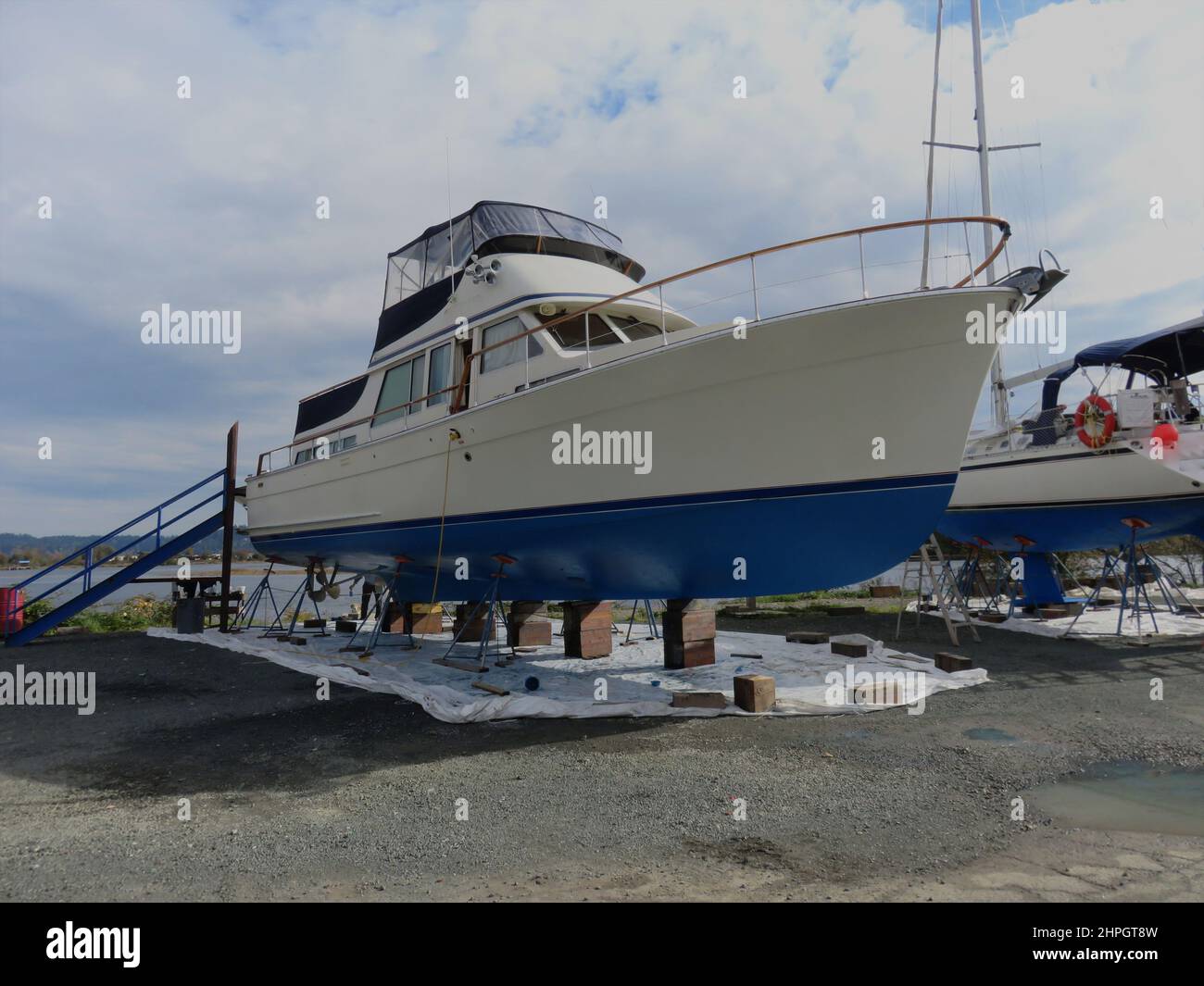 Pleasure boat in shipyard on blocks Stock Photo - Alamy