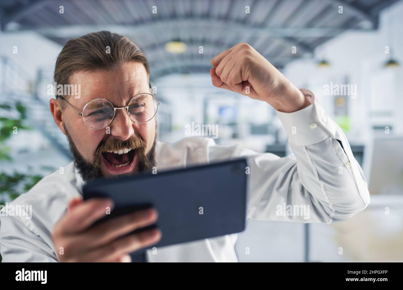Successful man with tablet Stock Photo - Alamy