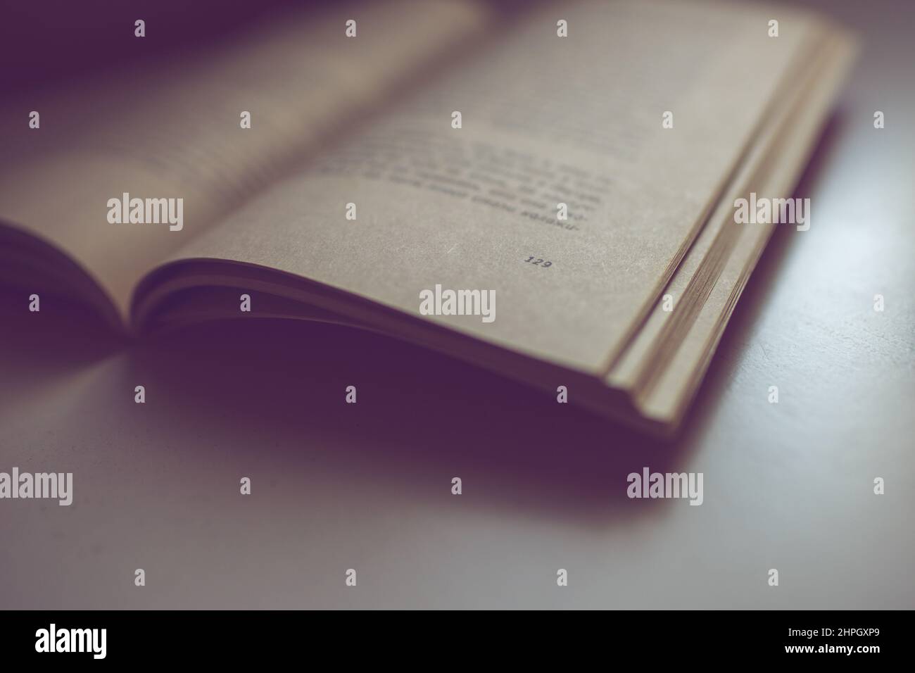 Open book on the table. Side view Stock Photo - Alamy