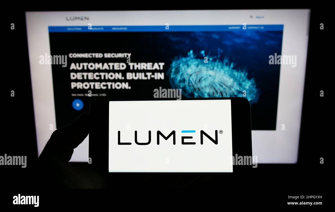Person holding mobile phone with logo of American telecom company Lumen ...