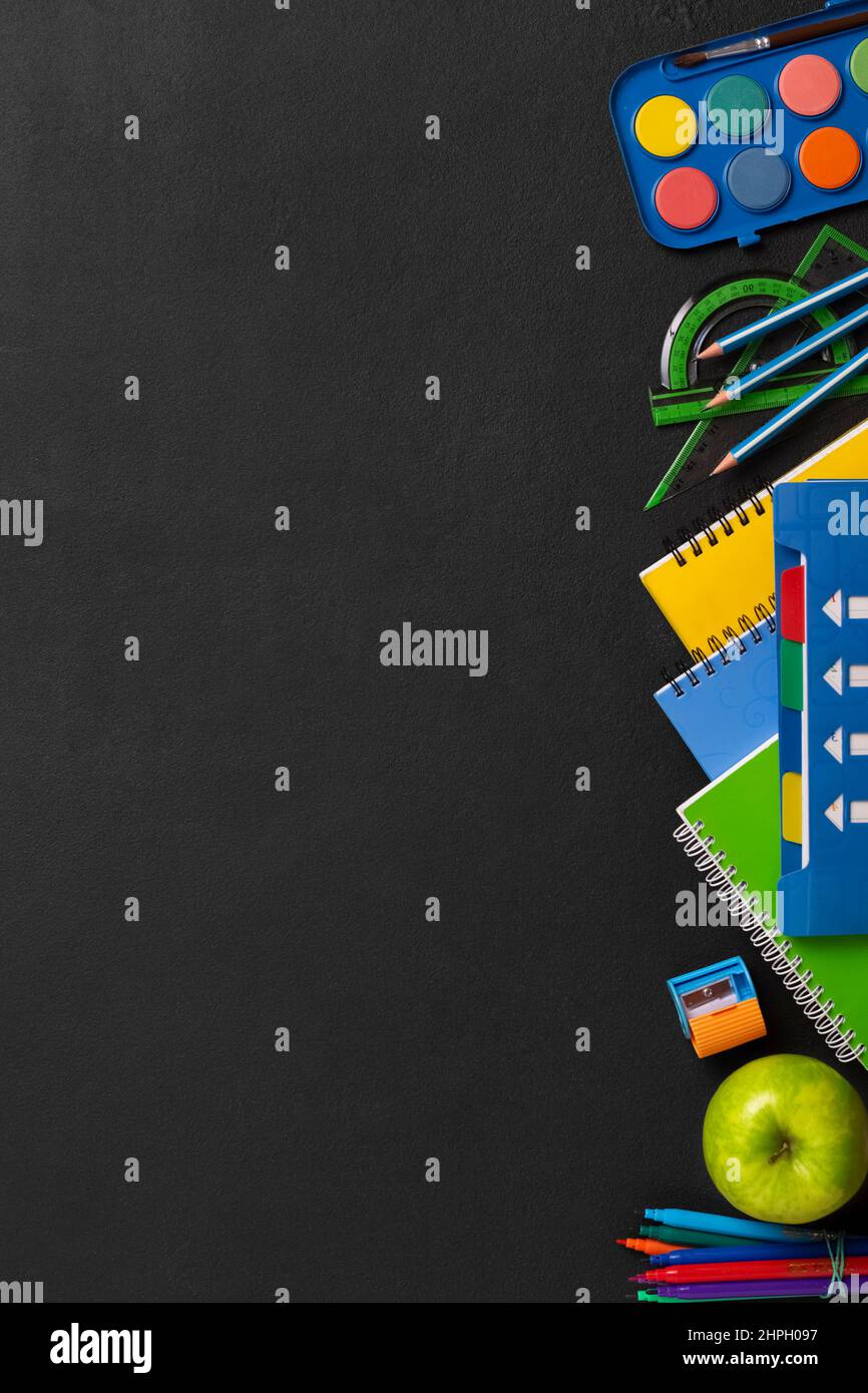 Black chalkboard school background with school supplies and stationery ...