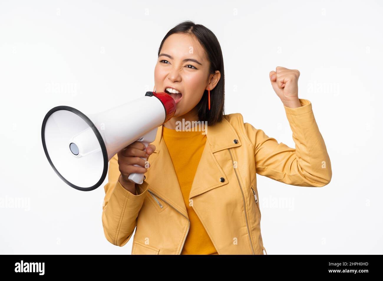 Portrait of young asian woman protester, screaming in megaphone and ...