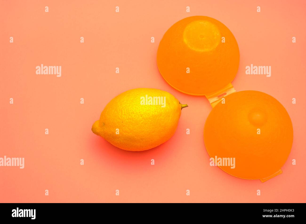 Lemon and its yellow plastic container to store the fruit Stock Photo ...