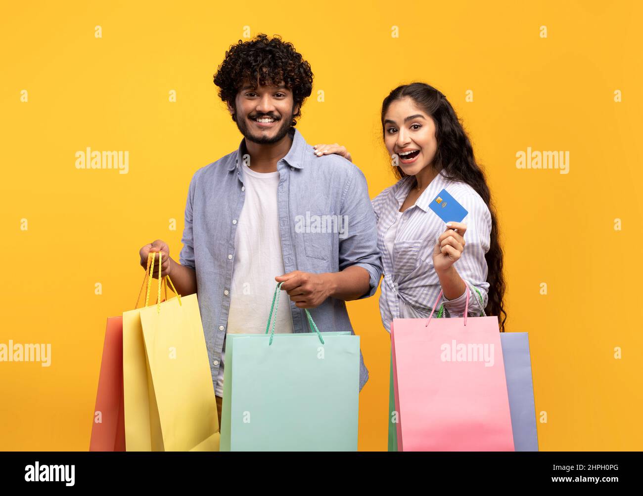 Consumerism concept. Excited indian couple with credit card and ...