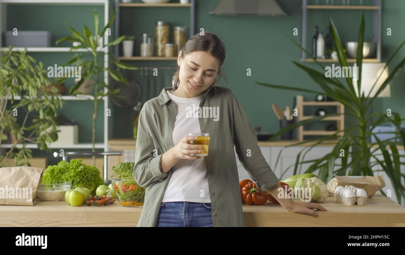 Happy Young Woman Enjoying Fresh-squeezed Juice Using Organic Products ...