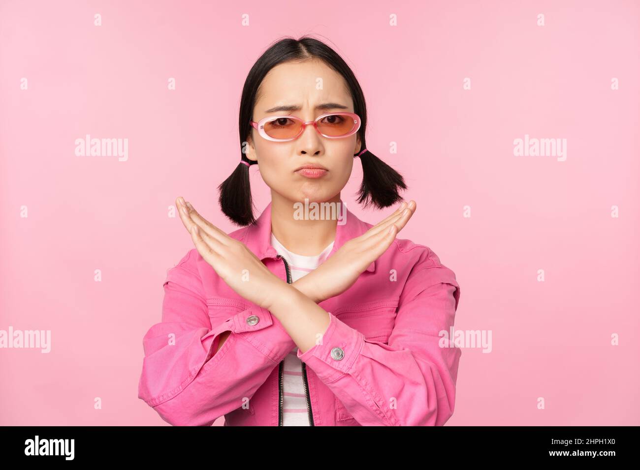 Portrait of korean girl in stylish sunglasses, sulking disappointed ...