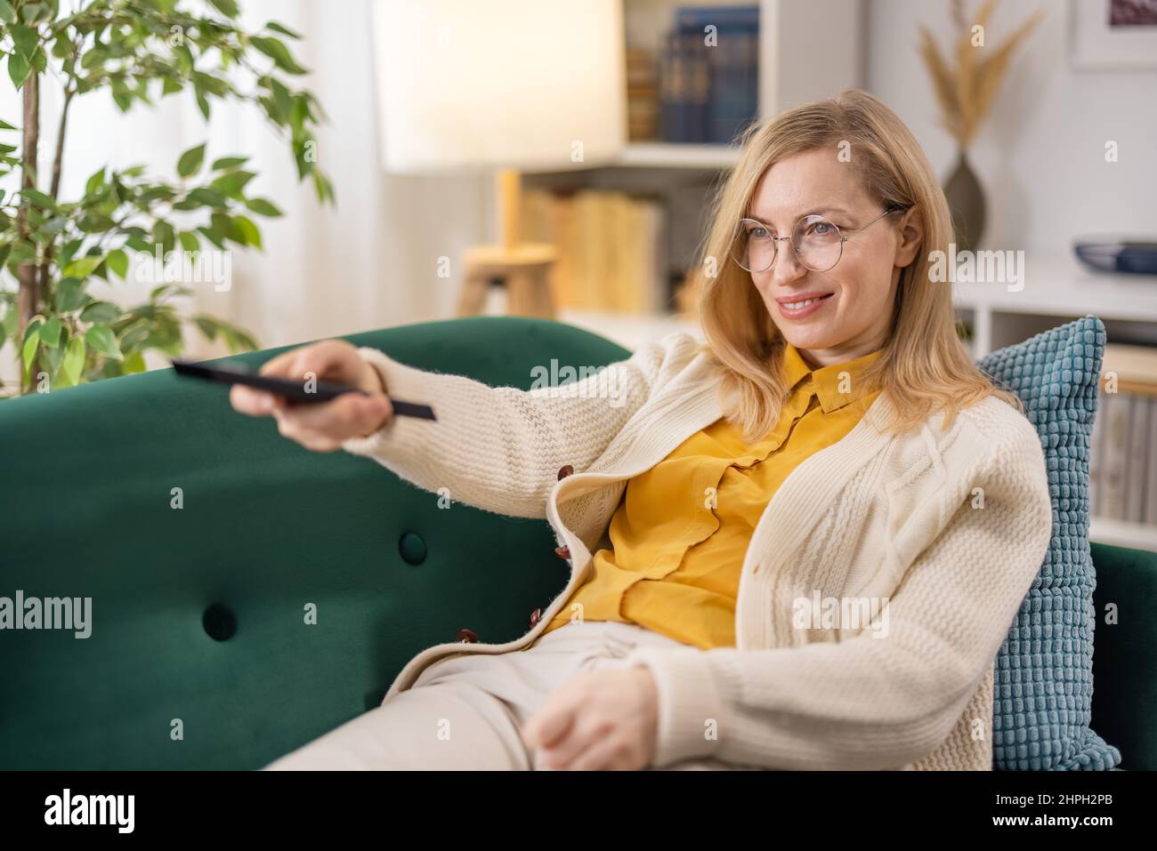 Mature woman and tv remote hi-res stock photography and images - Alamy