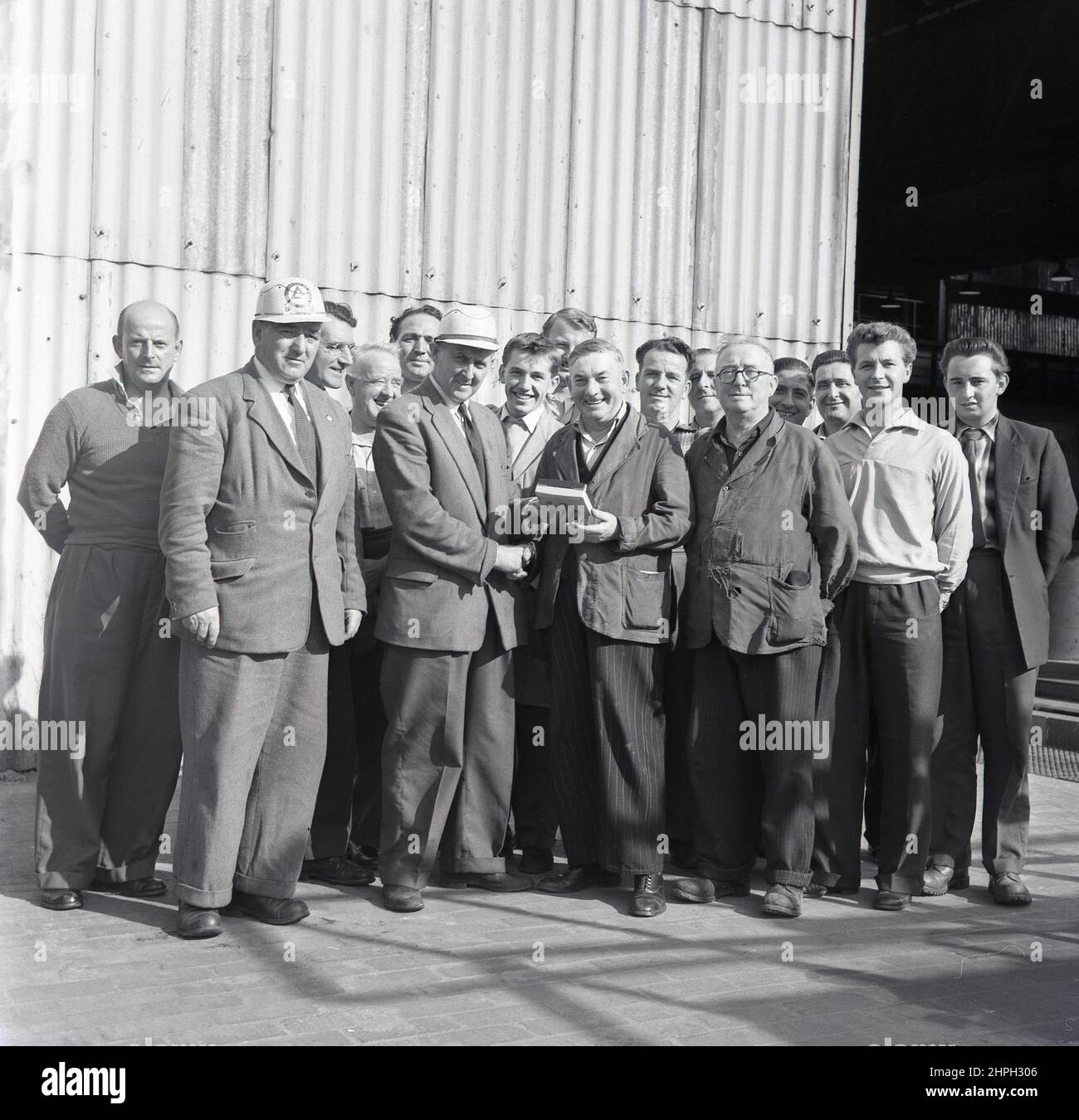 1950s, historical, happy faces as a group of steel workers gather ...