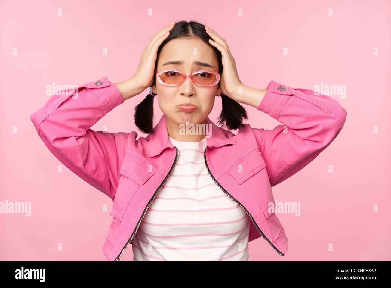 Portrait of troubled asian woman, korean girl holds hands on head and ...