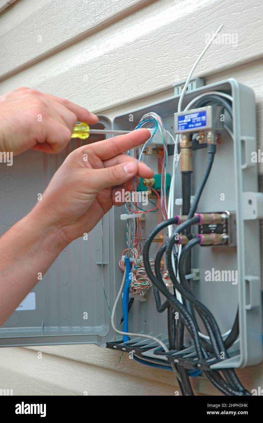 Installing cable TV and DSL lines and Phone lines on new house Stock ...