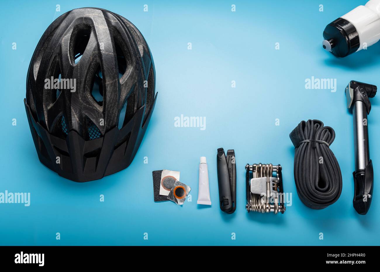 Minimal repair kit for a bike rider. Cycling helmet and bicycle repair ...