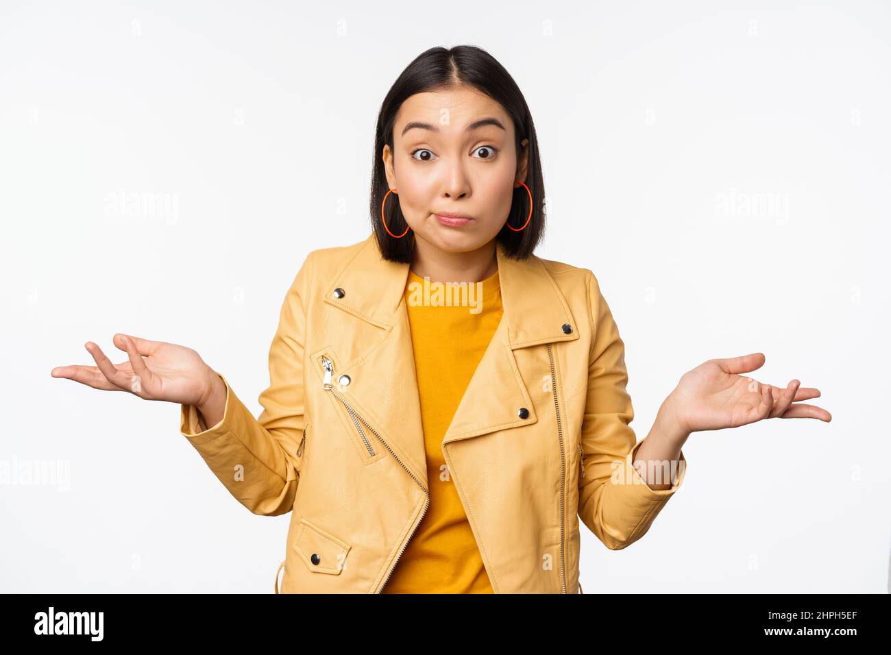 Image of korean girl shrugs shoulders and looks confused, dont know ...