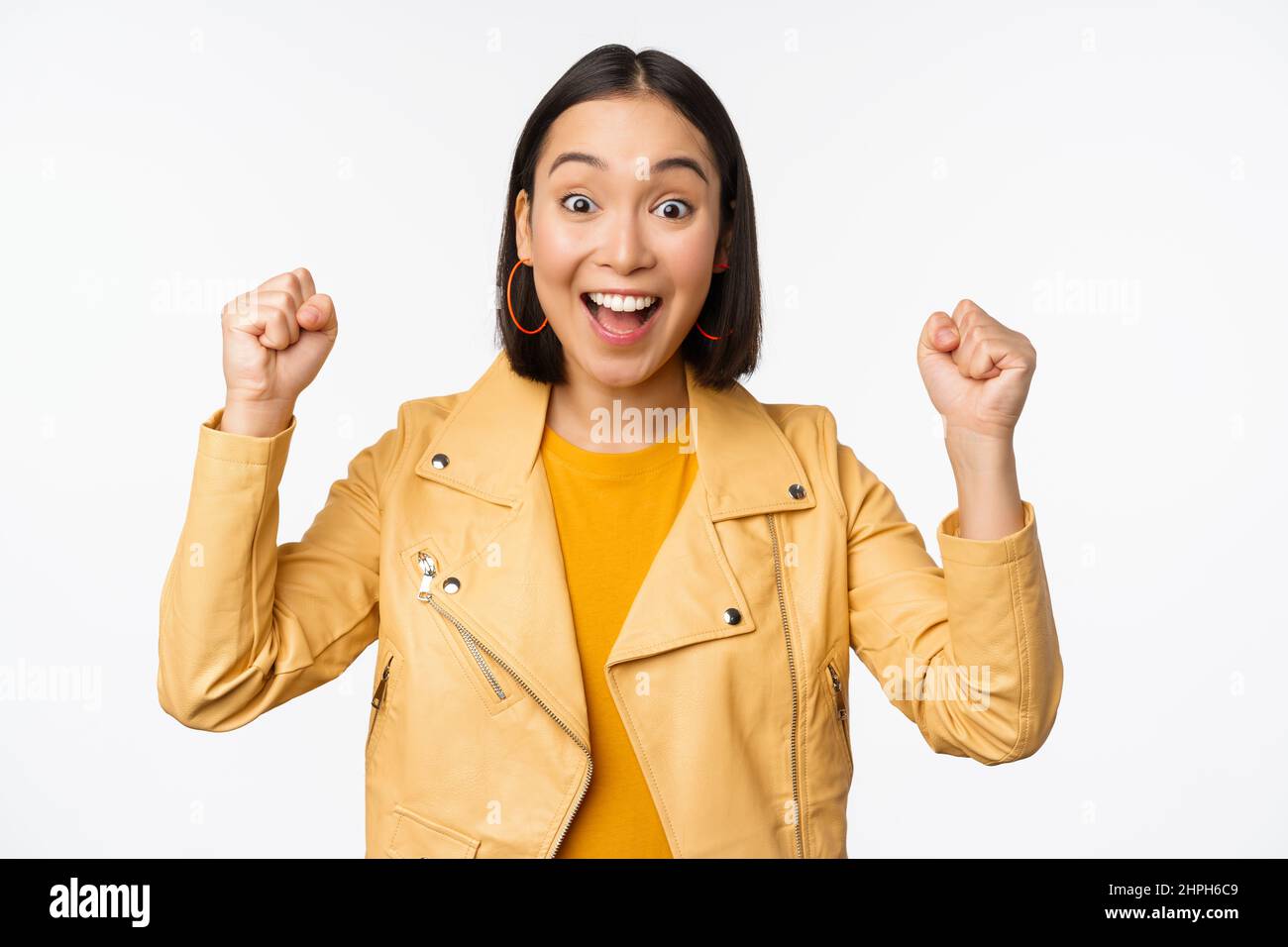 Image of asian woman dancing and smiling happy, celebrating victory ...