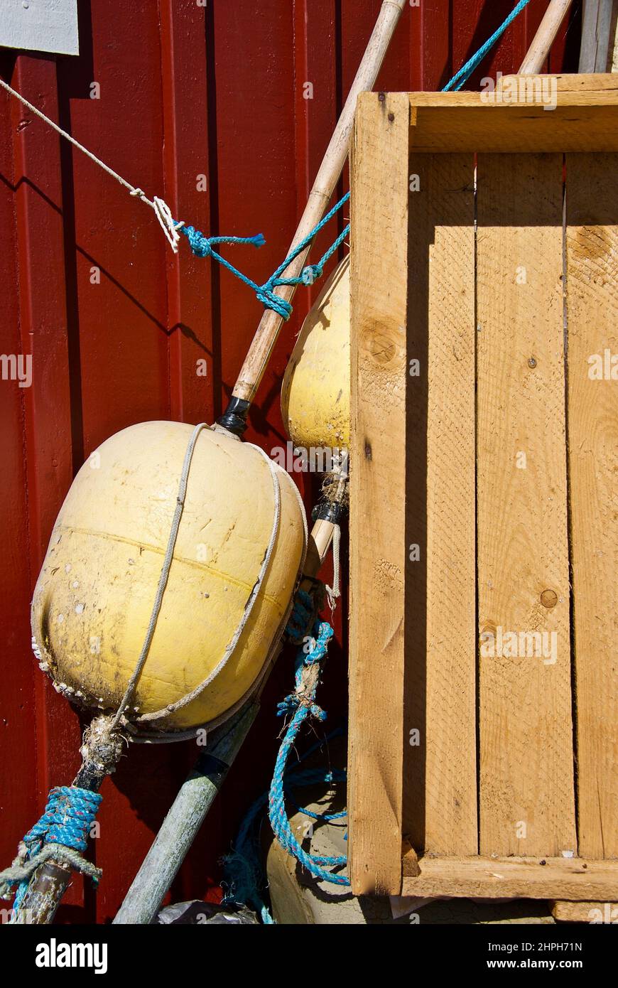 Wooden box for fish and standing floating poles in a small fishing ...